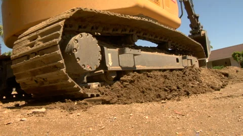 Excavator digging up road | Stock Video | Pond5