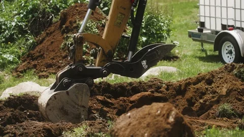 Excavator digging with water tanks and t... | Stock Video | Pond5