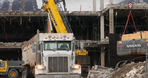 Excavator heavy demolition into truck co... | Stock Video | Pond5