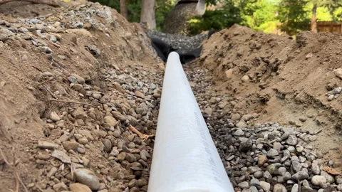 Excavator Installing Residential Drainag... | Stock Video | Pond5