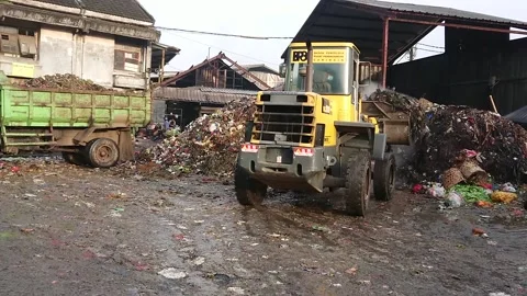 Excavator lifts garbage from landfill to... | Stock Video | Pond5