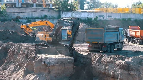 The excavator loading crushed stone into... | Stock Video | Pond5