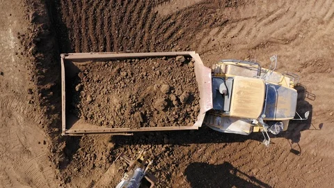 Excavator loading soil onto an Articulat... | Stock Video | Pond5