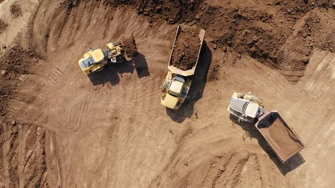 Excavator loading soil onto an Articulat... | Stock Video | Pond5