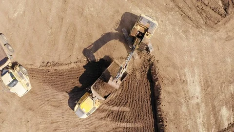 Excavator loading soil onto an Articulat... | Stock Video | Pond5