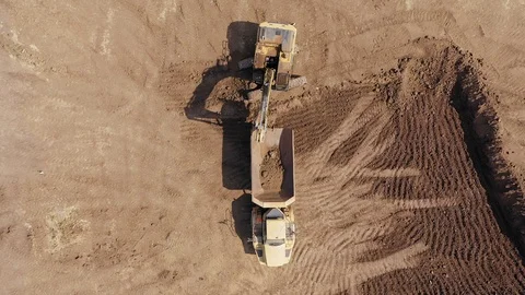 Excavator loading soil onto an Articulat... | Stock Video | Pond5