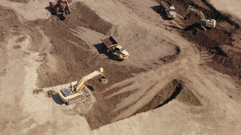 Excavator loading soil onto an Articulat... | Stock Video | Pond5