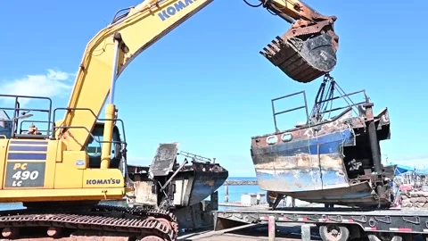 Excavator lowering hull of fire-damaged ... | Stock Video | Pond5