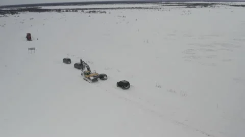 An excavator makes its way through snowd... | Stock Video | Pond5