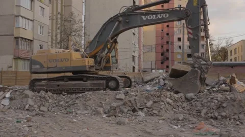 Excavator in the yard of destroyed build... | Stock Video | Pond5