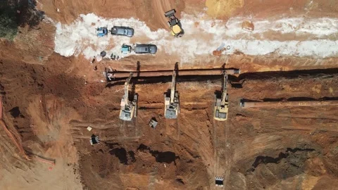 Excavators holding a big pipe line in co... | Stock Video | Pond5
