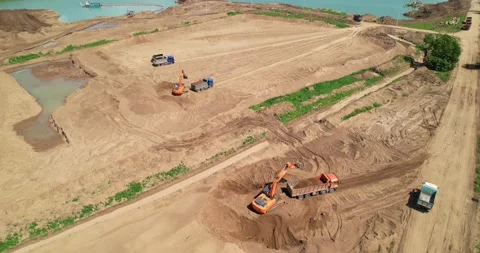 Excavators loading sand onto dump trucks | Stock Video | Pond5
