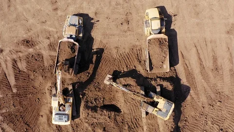 Excavators loading soil onto an Articula... | Stock Video | Pond5
