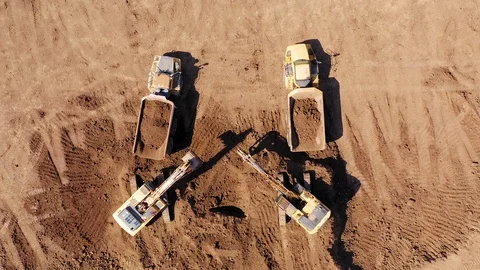 Excavators loading soil onto an Articula... | Stock Video | Pond5