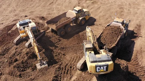 Excavators loading soil onto an Articula... | Stock Video | Pond5