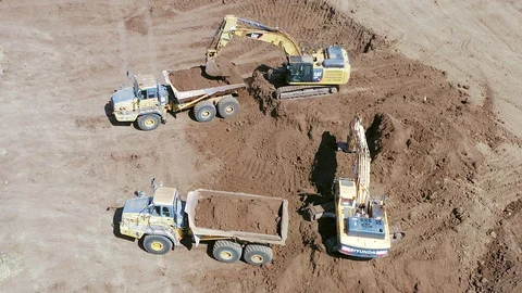 Excavators loading soil onto an Articula... | Stock Video | Pond5