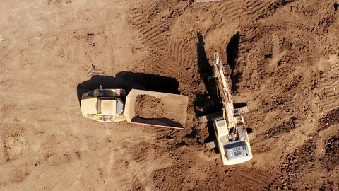 Excavators loading soil onto an Articula... | Stock Video | Pond5