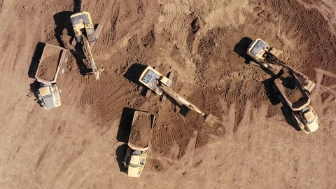 Excavators loading soil onto an Articula... | Stock Video | Pond5