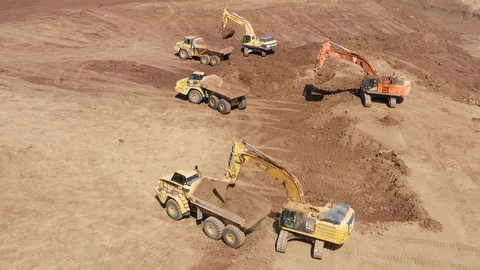 Excavators loading soil onto an Articula... | Stock Video | Pond5