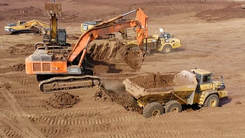 Excavators loading soil onto an Articula... | Stock Video | Pond5