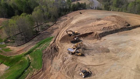Excavators loading soil onto an Articula... | Stock Video | Pond5