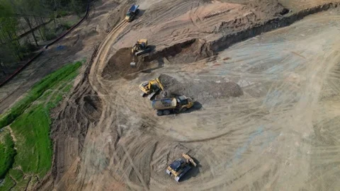 Excavators loading soil onto an Articula... | Stock Video | Pond5