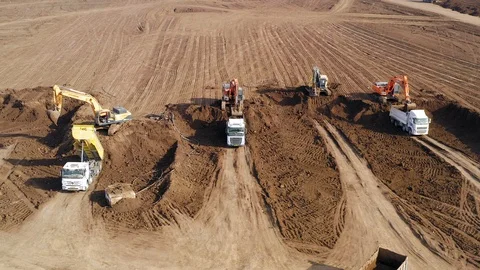 Excavators loading soil onto Trucks, Aer... | Stock Video | Pond5
