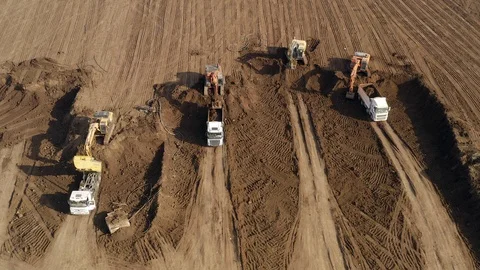 Excavators loading soil onto Trucks, Aer... | Stock Video | Pond5