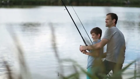 Excited father and son pulling fish out ... | Stock Video | Pond5