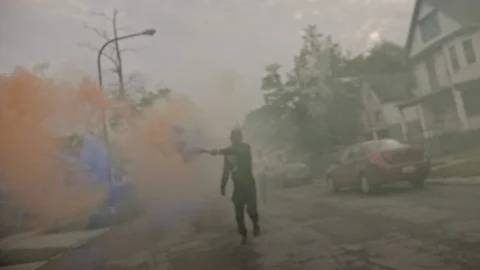 Excited man running with blue smoke stic... | Stock Video | Pond5