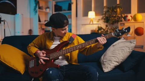 Excited teenage boy playing bass guitar ... | Stock Video | Pond5