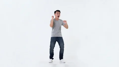 Excited young Asian man dancing | Stock Video | Pond5