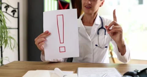An exclamation mark on paper in the hand... | Stock Video | Pond5