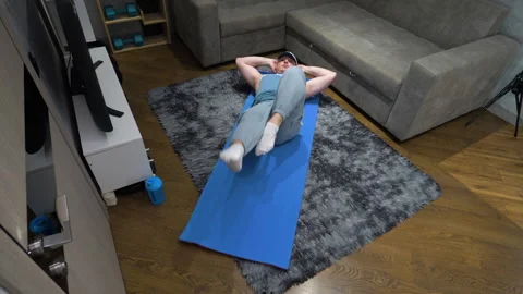 Exercise to lift legs up in a lying posi... | Stock Video | Pond5