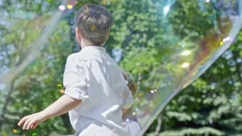 Exhilarated Kids Catching Bubbles in Par... | Stock Video | Pond5
