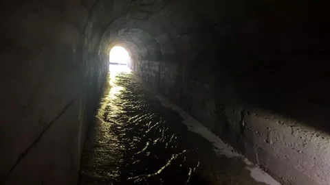 Exit the dark tunnel. The light at the e... | Stock Video | Pond5