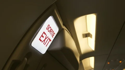 Exit Sortie sign. Interior of jet plane.... | Stock Video | Pond5