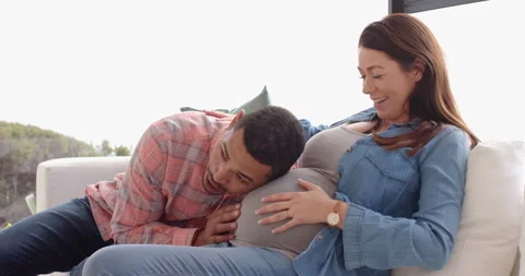 Expectant father listening to pregnant b... | Stock Video | Pond5