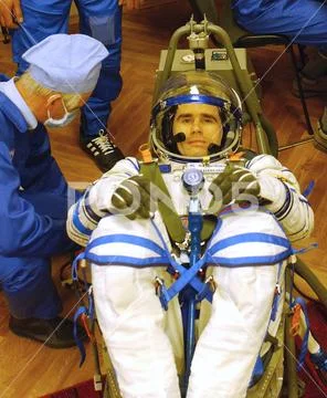 Expedition 7 Commander Yuri I. Malenchenko has a leak check performed ...