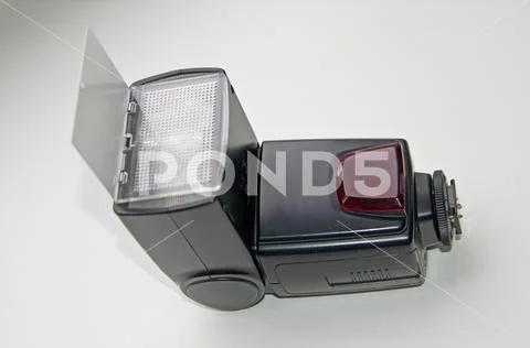 External flash for a SLR camera, on a gray background Stock Image #95310356