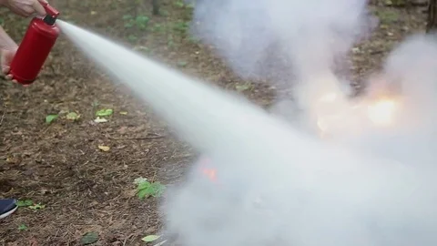 Extinguishing open fire with a powder fi... | Stock Video | Pond5
