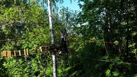 Extreme rope adventure in the summer par... | Stock Video | Pond5