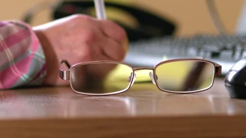 Eye glasses with woman writing on sticky... | Stock Video | Pond5