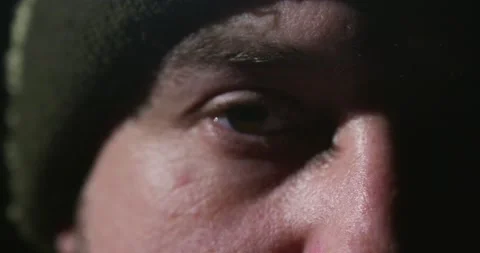 eye of a man in a green hat on a black b... | Stock Video | Pond5