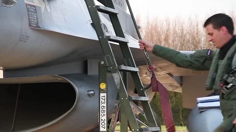 F-16 pilot climbing ladder to cockpit | Stock Video | Pond5