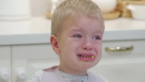 face of a crying child at the dinner tab... | Stock Video | Pond5