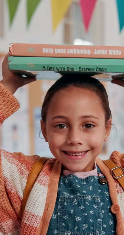Face, girl and books on head at school f... | Stock Video | Pond5