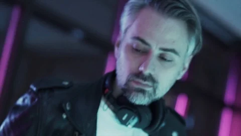 Face of man DJ with headphones on neck a... | Stock Video | Pond5