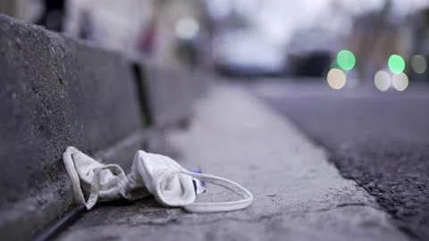 Face mask waste on ground pollution. Dis... | Stock Video | Pond5