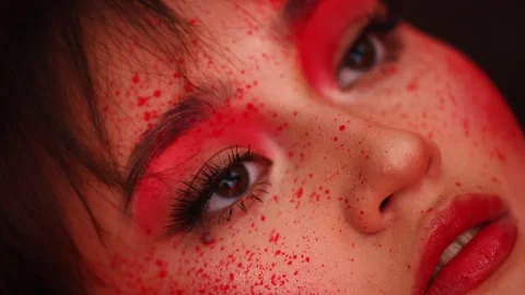 face of a model girl on a red background... | Stock Video | Pond5